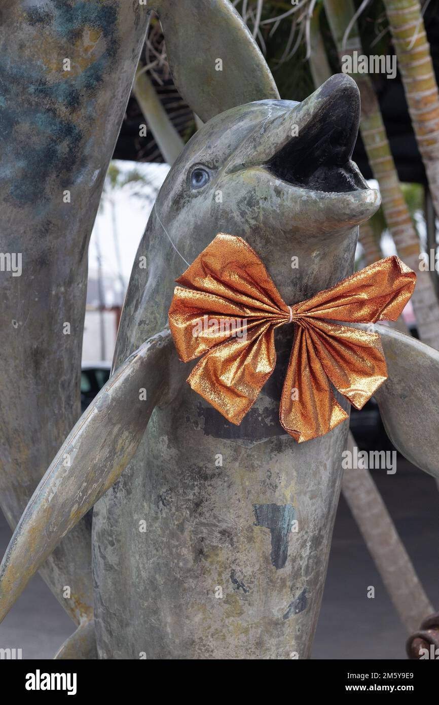 A dolphin statue decorated with a festive bow for Christmas, in Naples ...