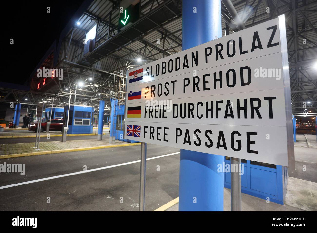 Police officers take down a sign at the Bregana border crossing after ...