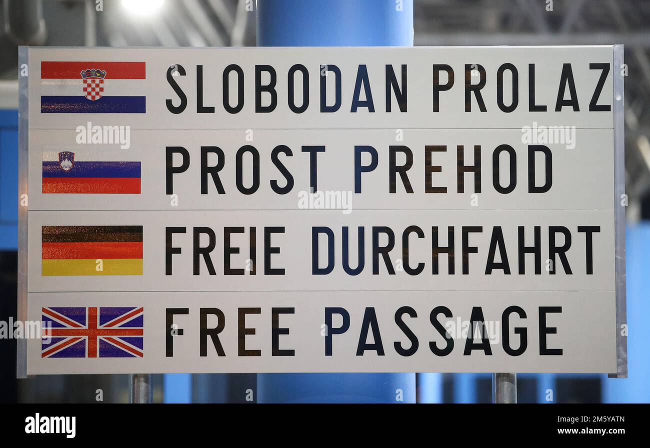 Police officers take down a sign at the Bregana border crossing after ...