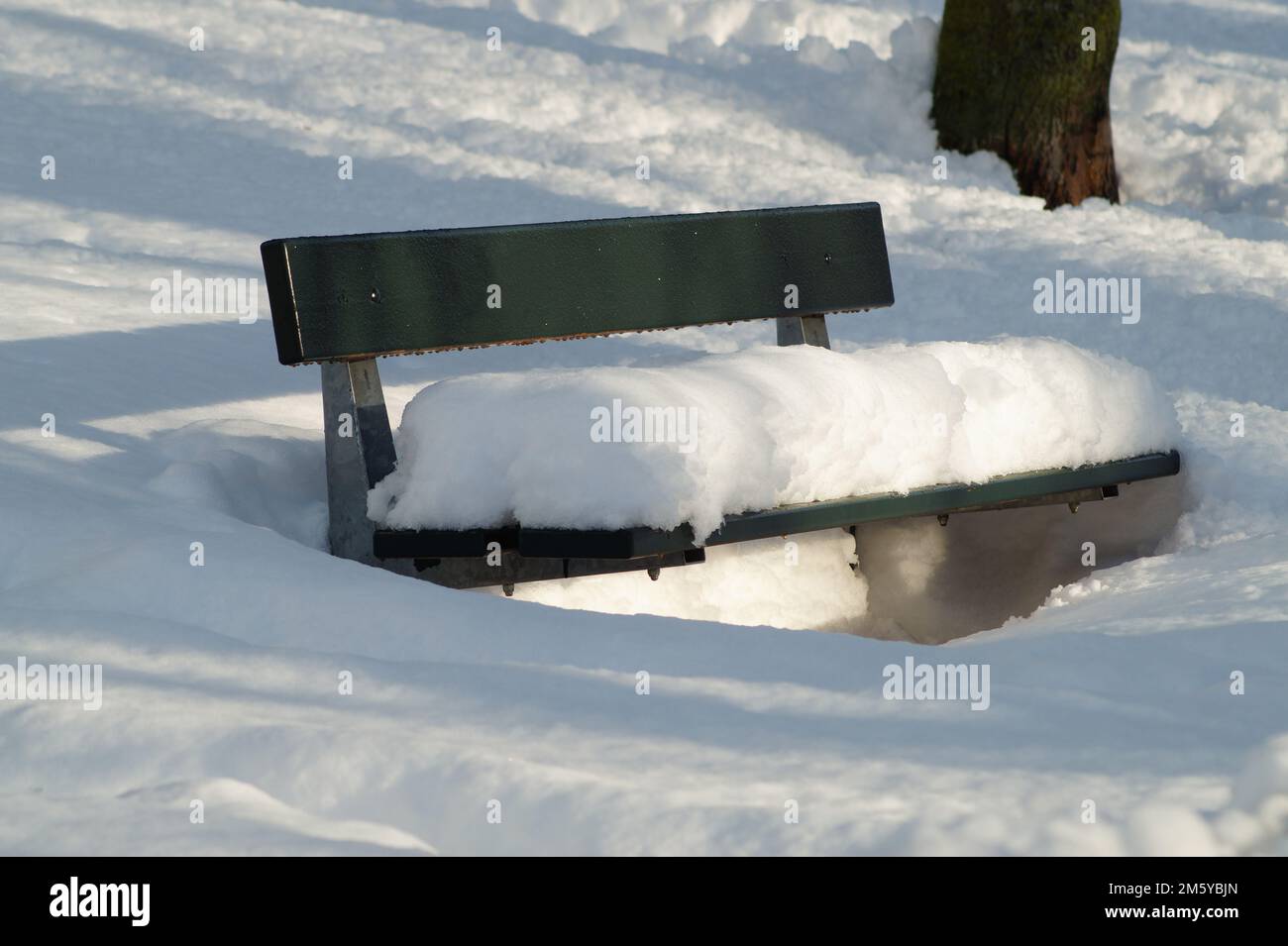 Snow covered bench during winter day Stock Photo - Alamy