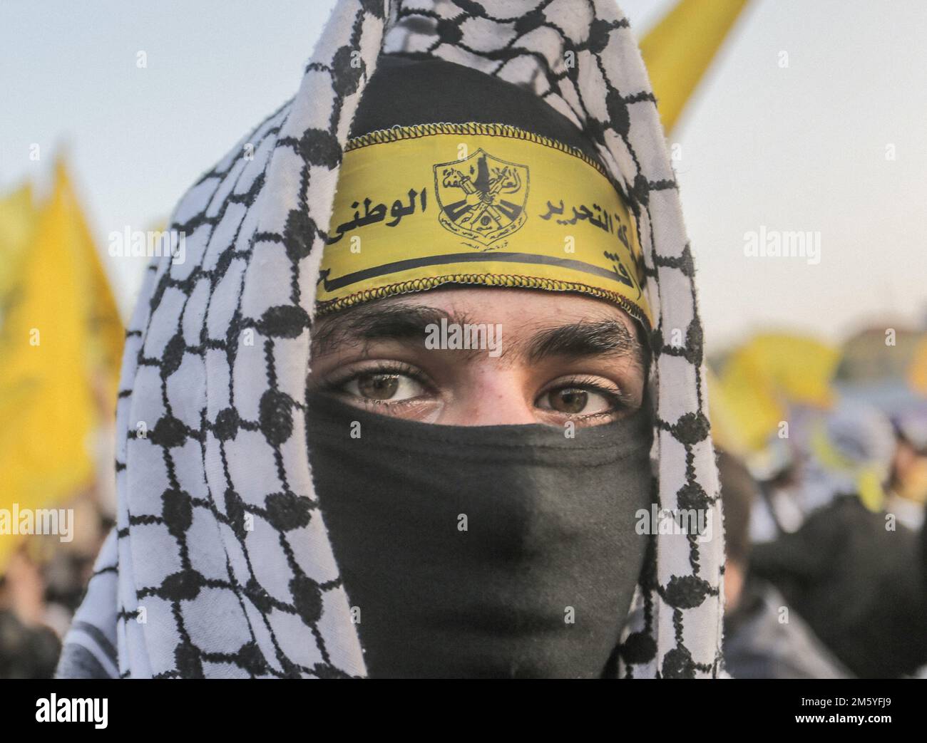 A Palestinian man wears a keffiyeh during the rally commemorating the ...