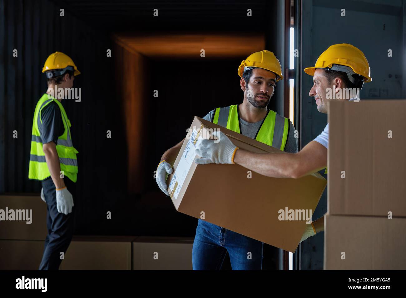 Worker carry carton box taken from 40 feet steel container on the ...