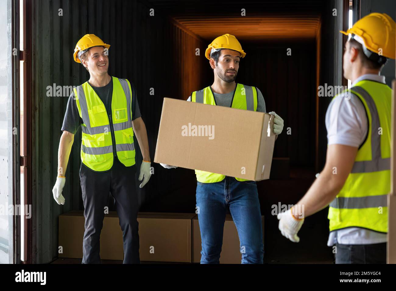 Worker carry carton box taken from 40 feet steel container on the ...