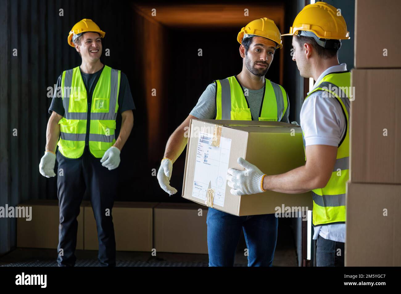 Worker carry carton box taken from 40 feet steel container on the ...
