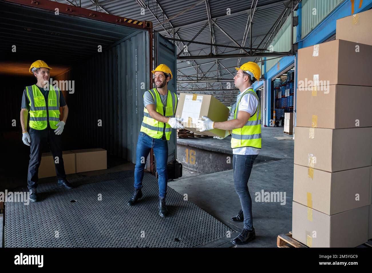 Worker carry carton box taken from 40 feet steel container on the ...