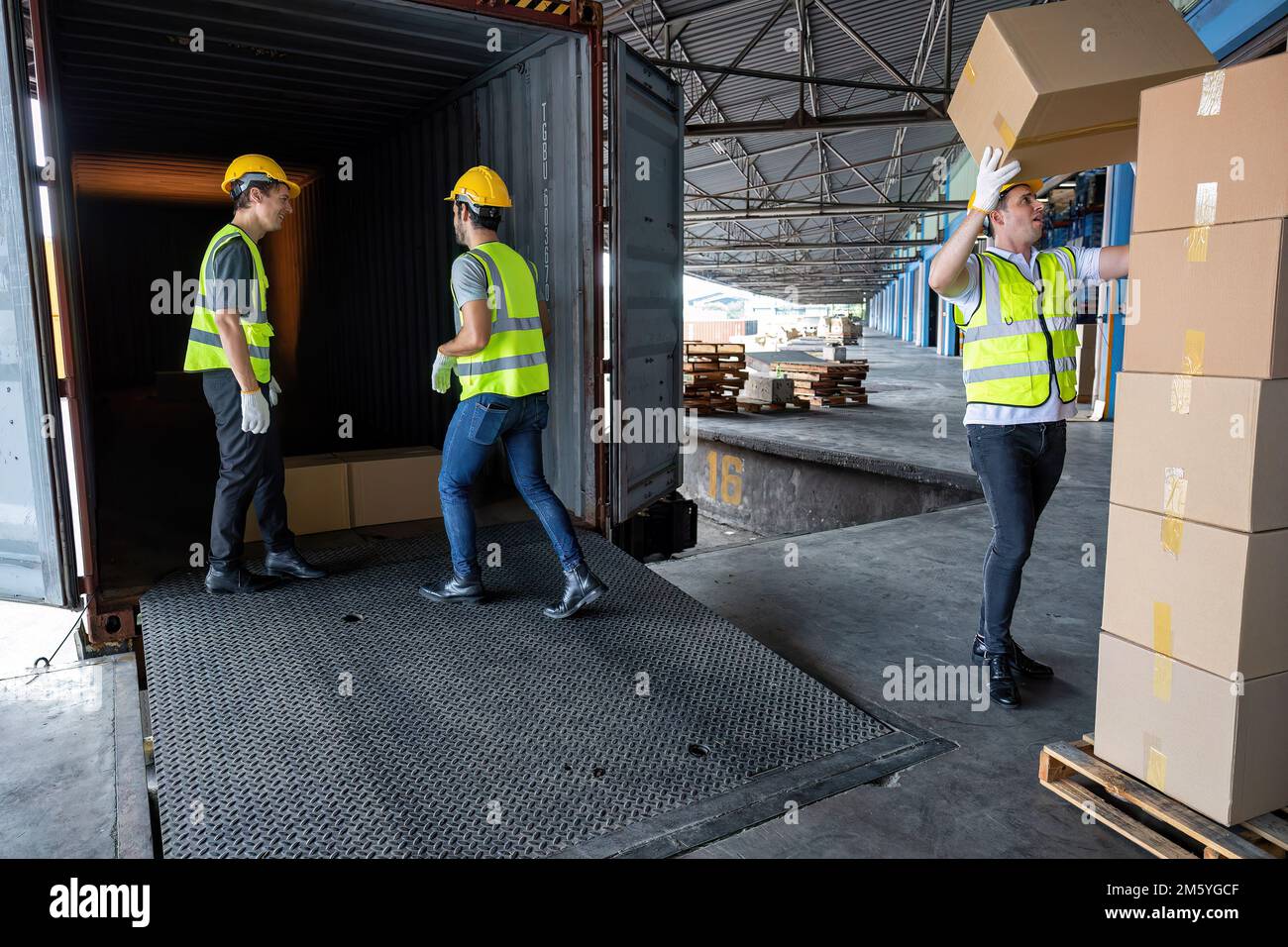 Worker carry carton box taken from 40 feet steel container on the ...