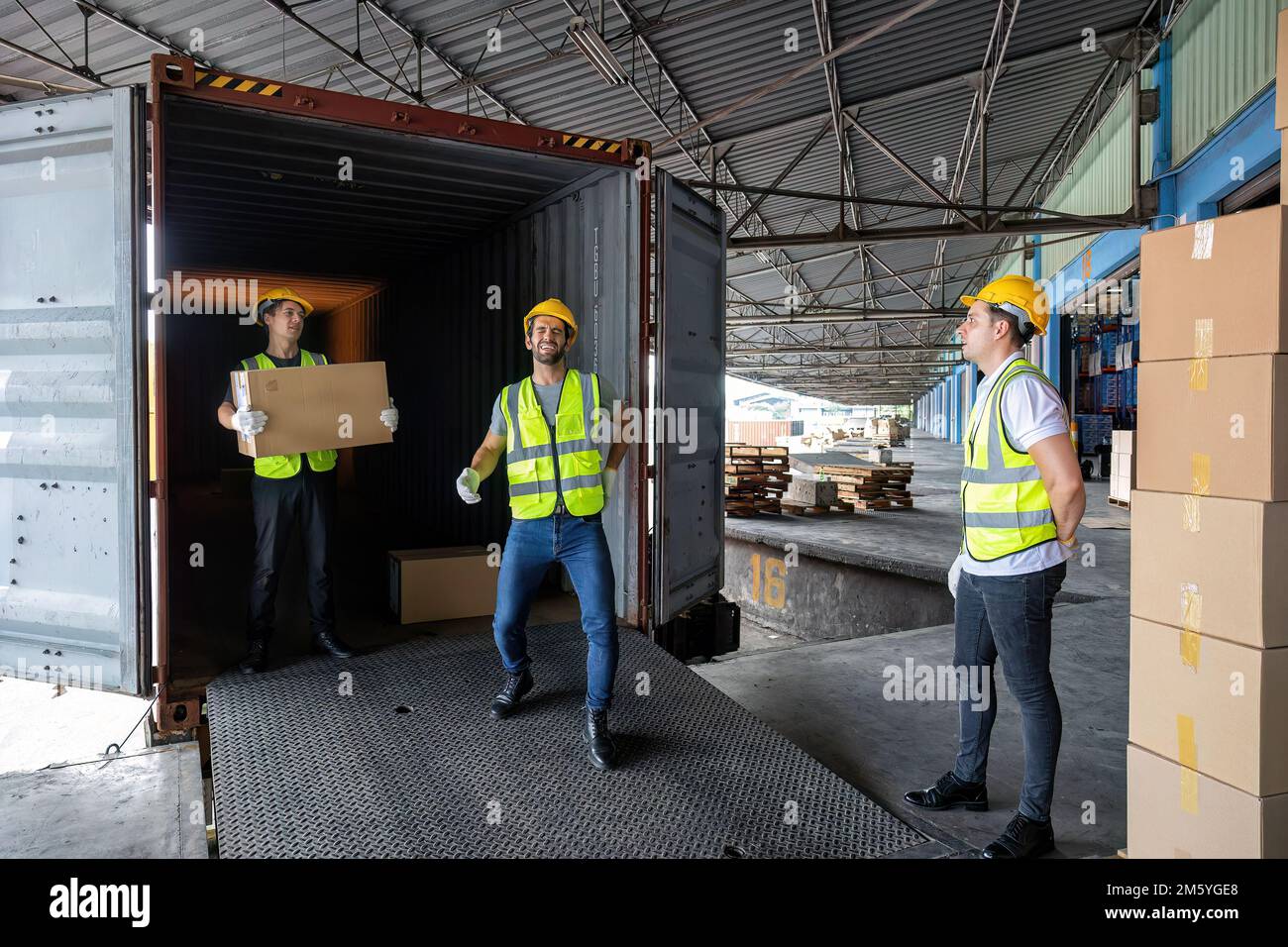 Worker carry carton box taken from 40 feet steel container on the ...