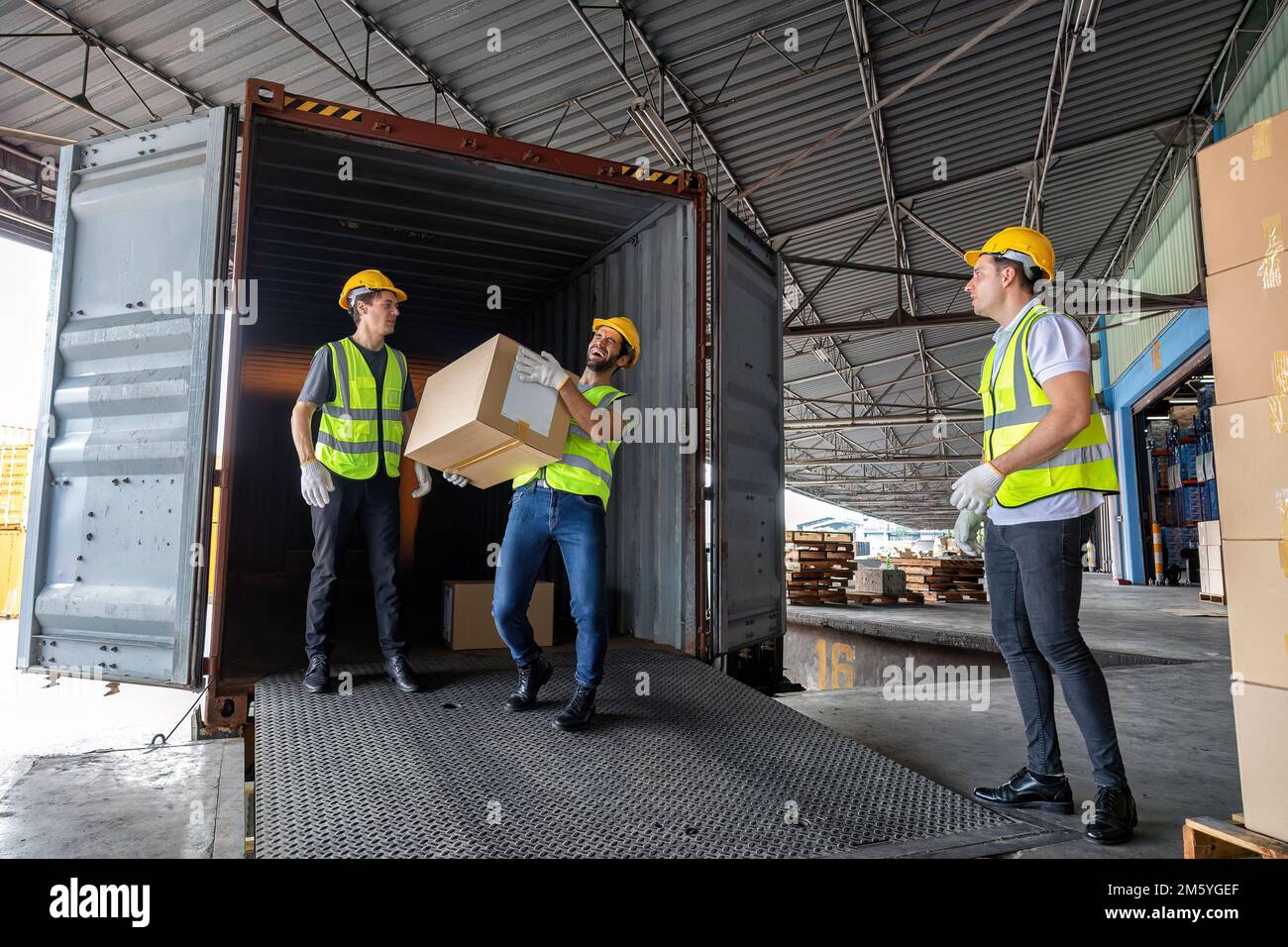 Worker carry carton box taken from 40 feet steel container on the ...
