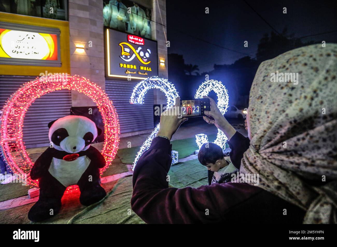 Gaza, Palestine. 31st Dec, 2022. A Palestinian young lady takes photos ...