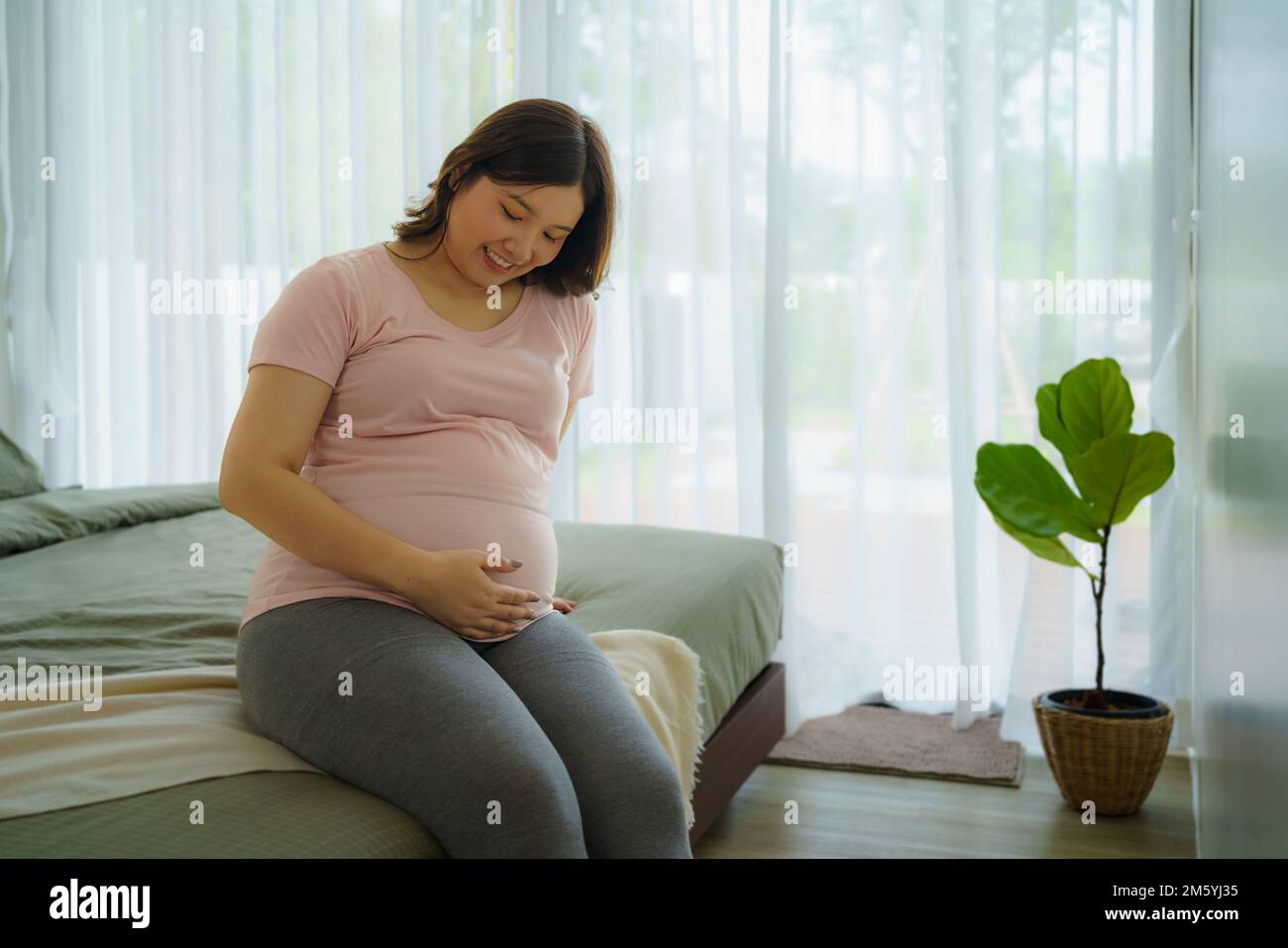 Pregnancy, people rest and expectation concept - Asian smiling happy ...