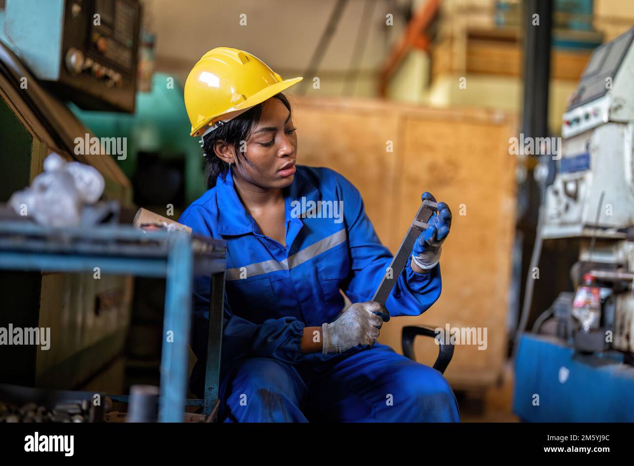 Mechanical girl in uniform on break time sitting check F wrench and ...