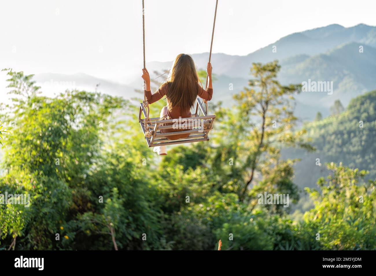 Traveler Girl Sitting On Swing Rope Hang From Tree Branch Swing On