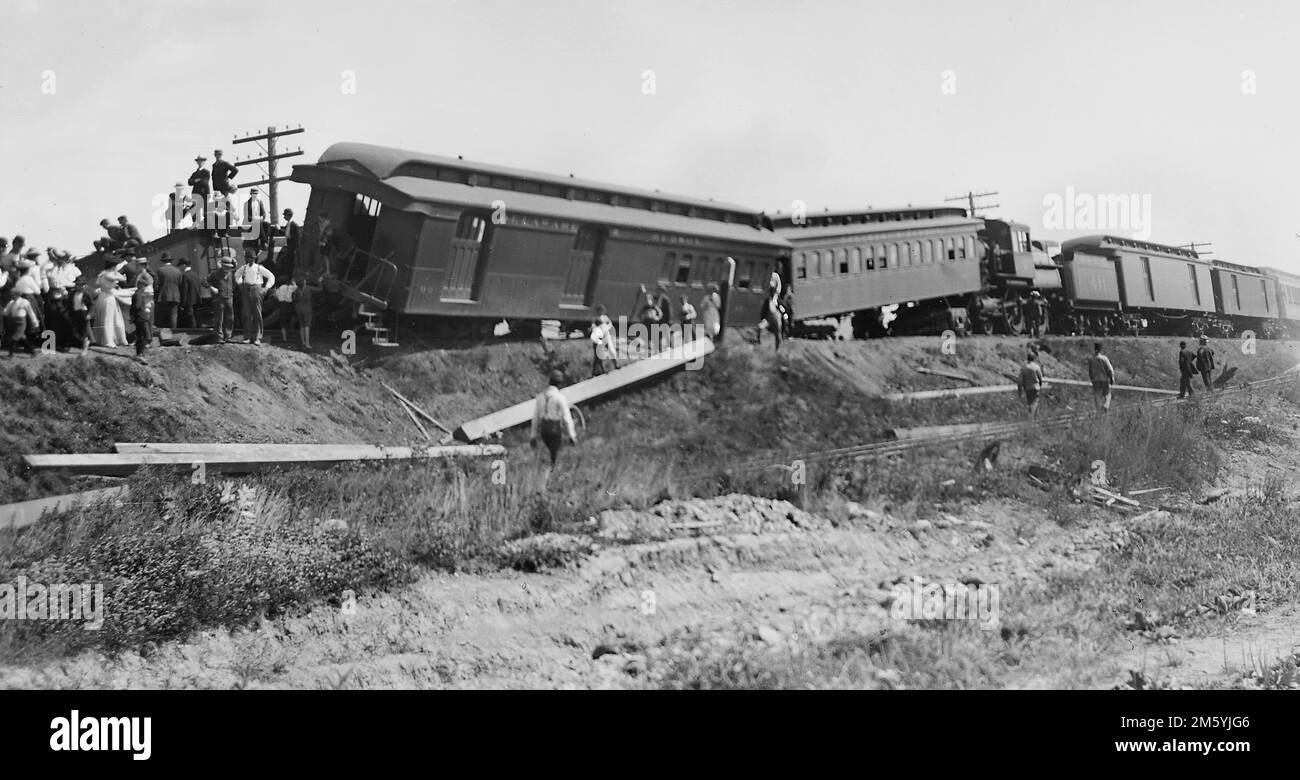 A crowd investigates a derailed Delaware Railroad train wreck, ca. 1890 ...