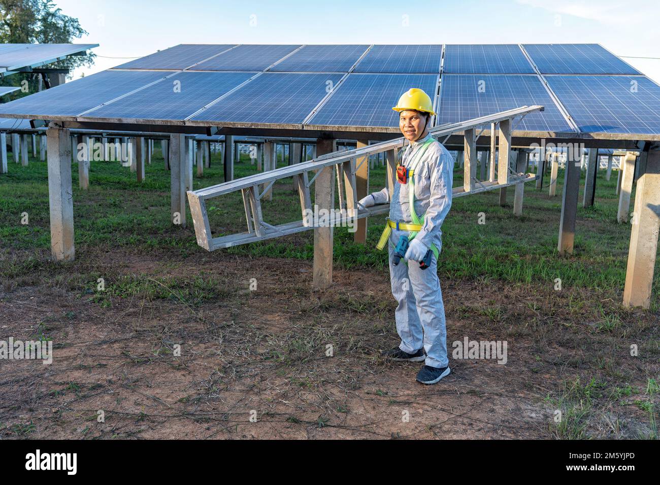 Maintenance engineer on duty cary step ladder stand portrait look ...