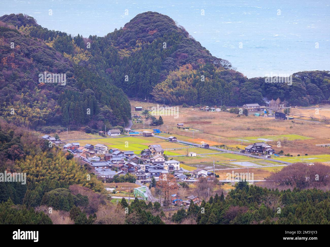 Small Japanese town on flat plain between forested hills and sea Stock ...