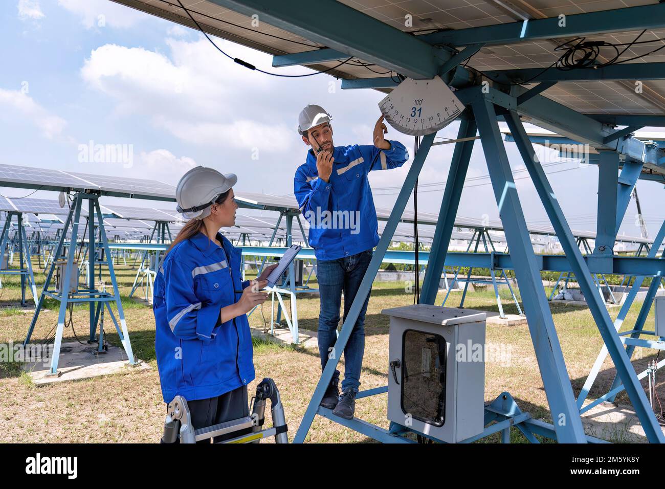 Maintenance engineer at solar farm stand on structure support checking ...