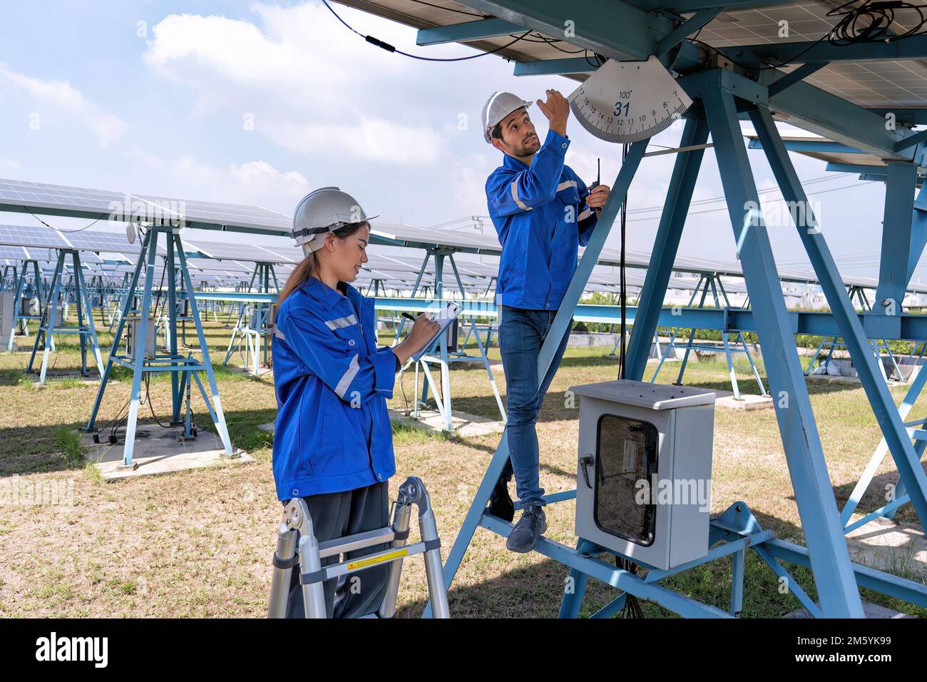 Maintenance engineer at solar farm stand on structure support checking ...