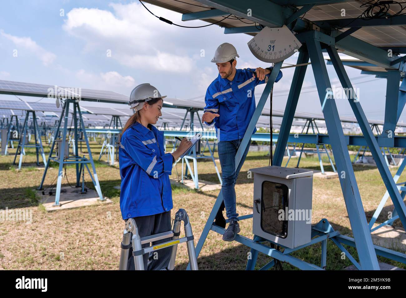 Maintenance engineer at solar farm stand on structure support checking ...