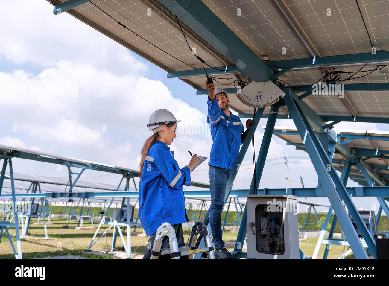 Maintenance engineer at solar farm stand on structure support checking ...