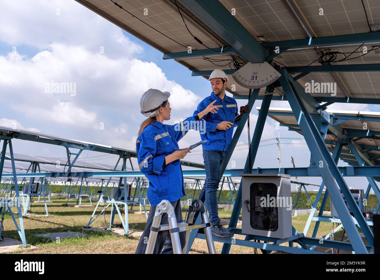 Maintenance engineer at solar farm stand on structure support checking ...