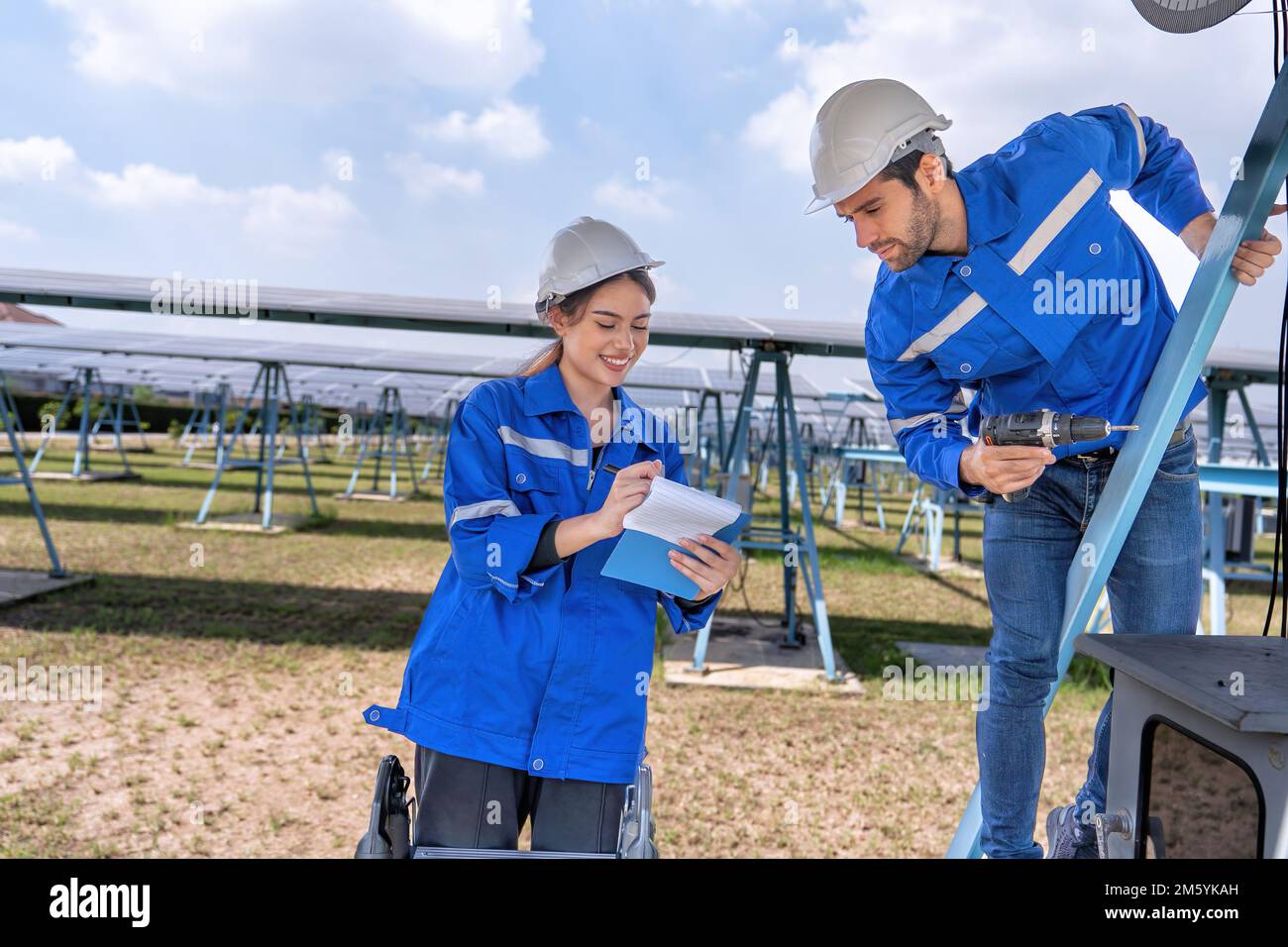 Maintenance engineer at solar farm stand on structure support checking ...