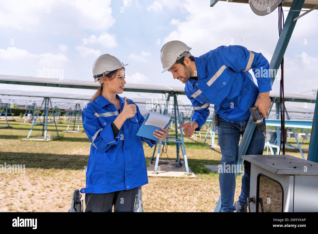 Maintenance engineer at solar farm stand on structure support checking ...