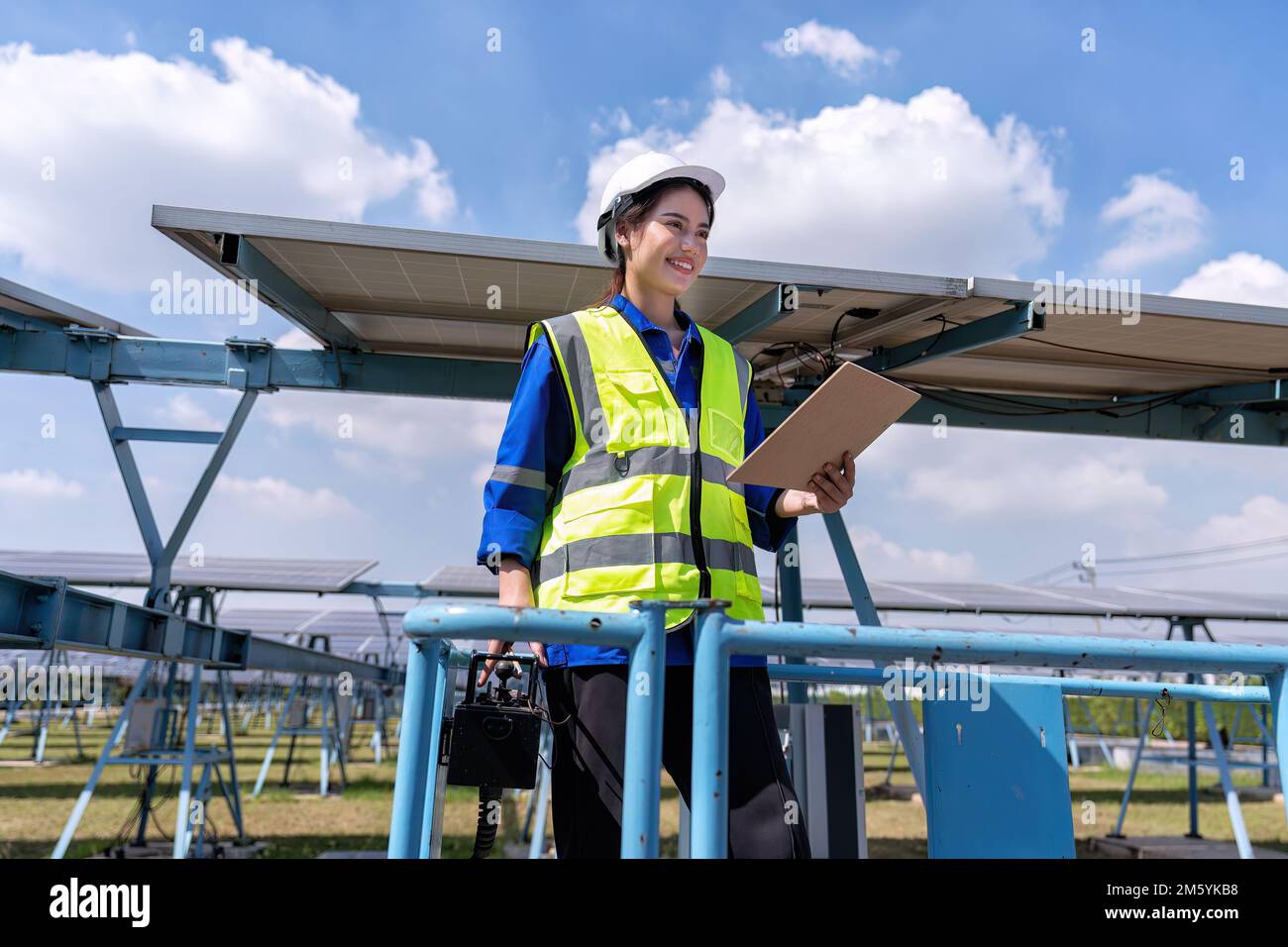 Maintenance engineer at solar farm stand on scissor lift hold check ...