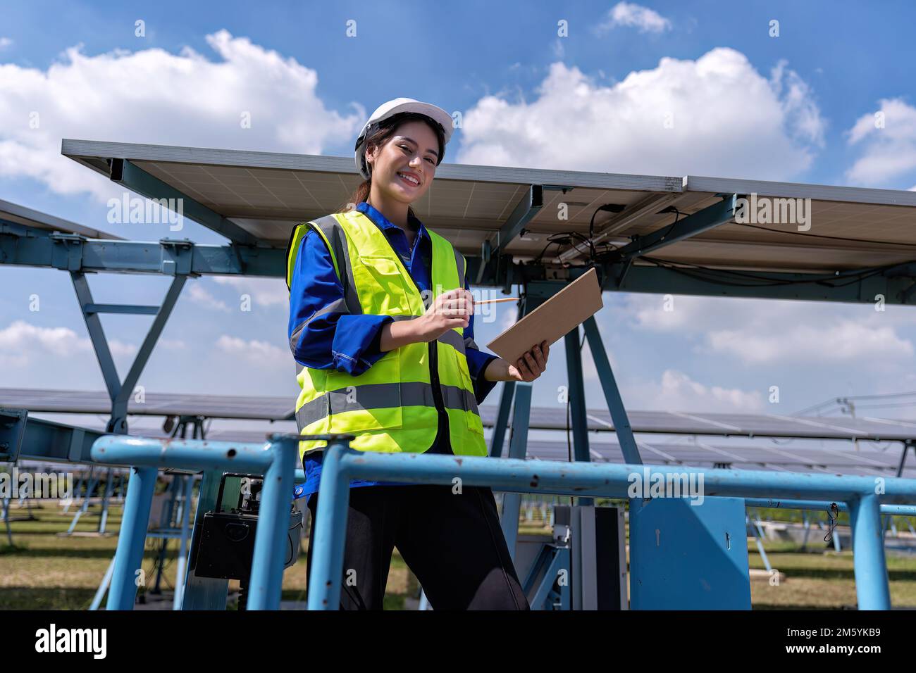 Maintenance engineer at solar farm stand on scissor lift hold check ...