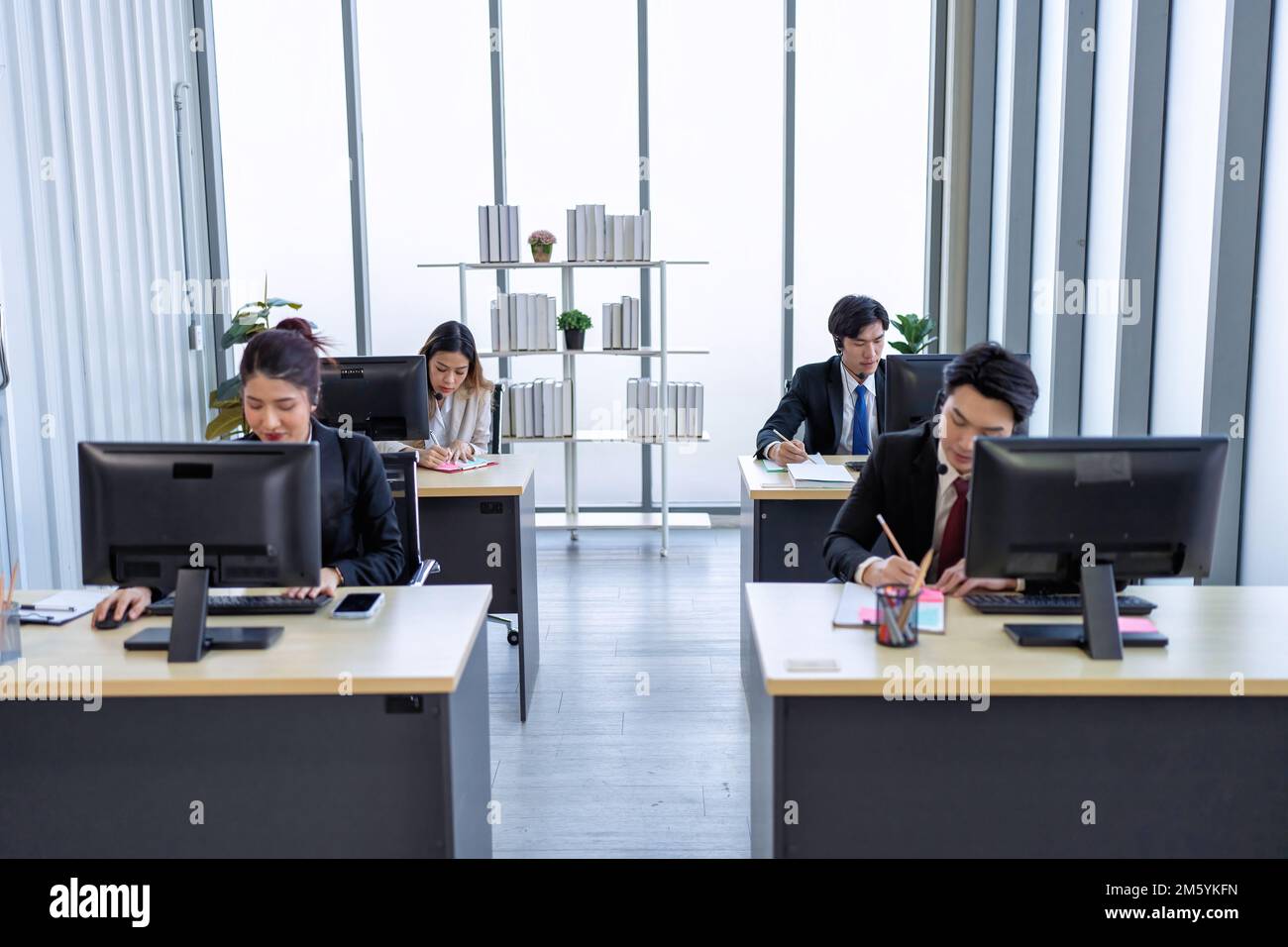 Business employee in formal suits working at table and discussing ...