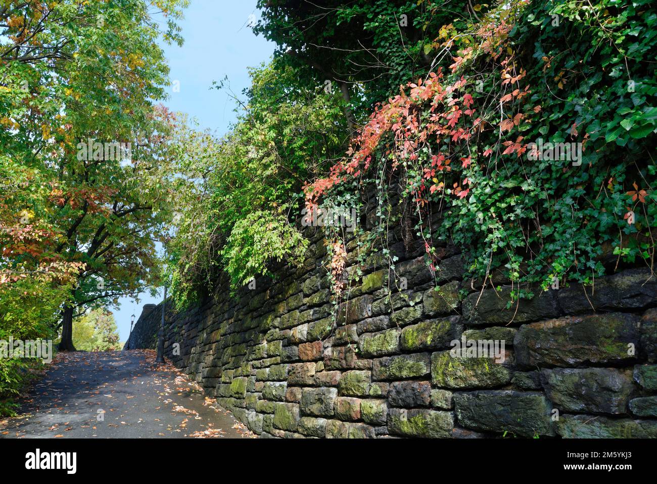 Stone wall beside path in Fort Tryon Park going up the hill to the Met ...