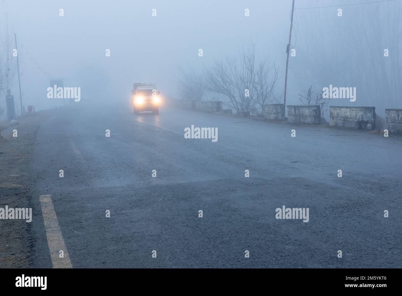 Car driving in fog on a highway in bad foggy weather with low ...
