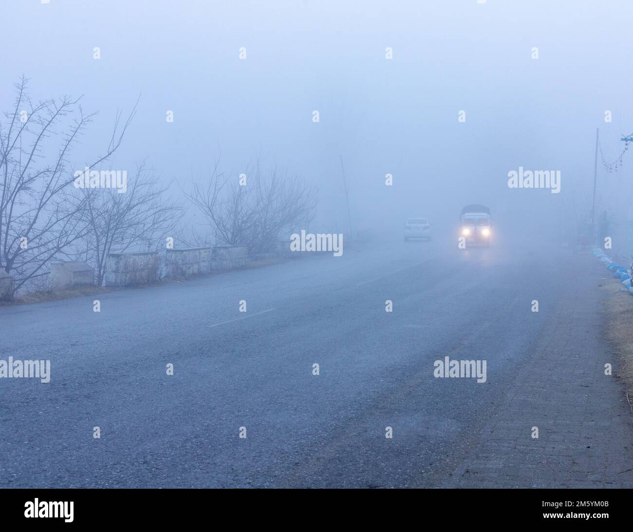 Car with lights on a highway in fog Stock Photo - Alamy