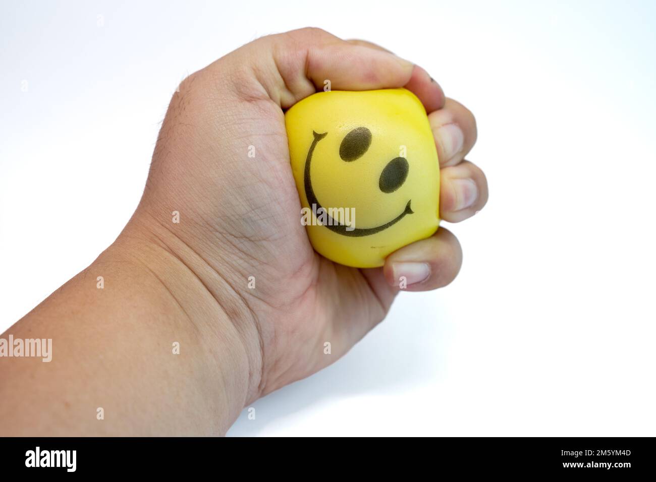 Hand squeeze yellow stress ball, isolated on white background, anger ...