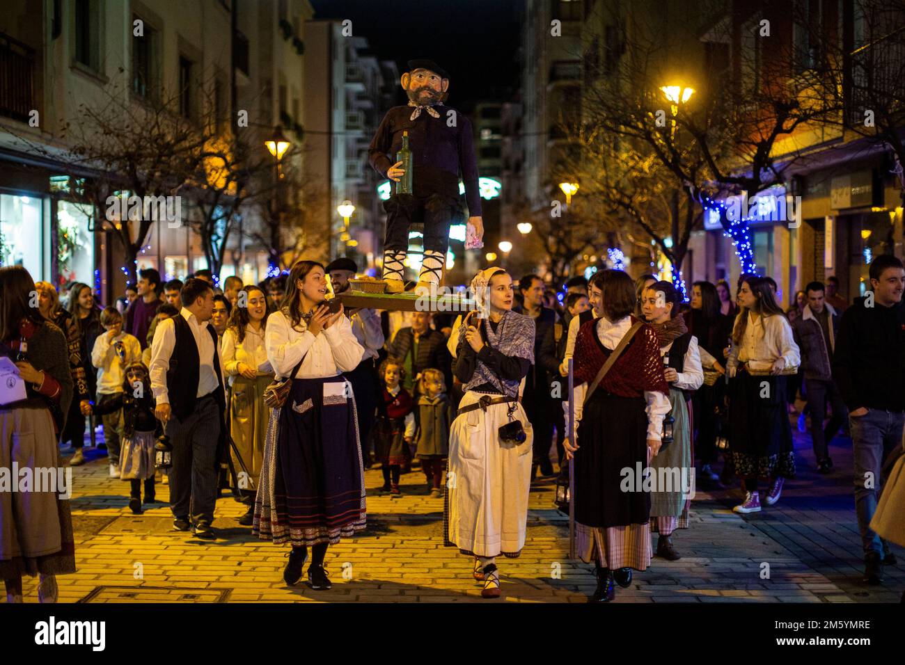 Members of the Txindurri dance group carry the figure of the Olentzero ...