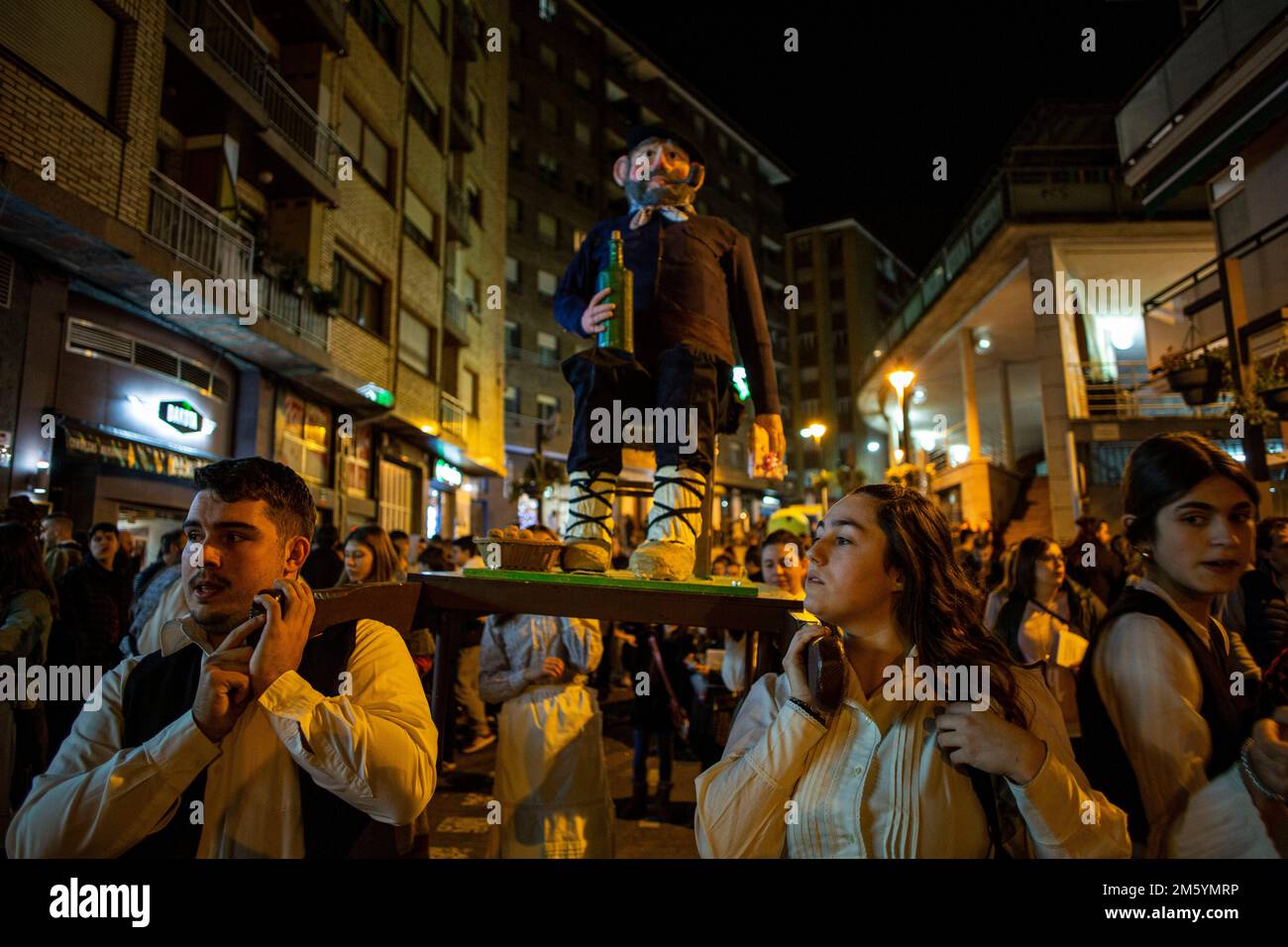 Members of the Txindurri dance group carry the figure of the Olentzero ...