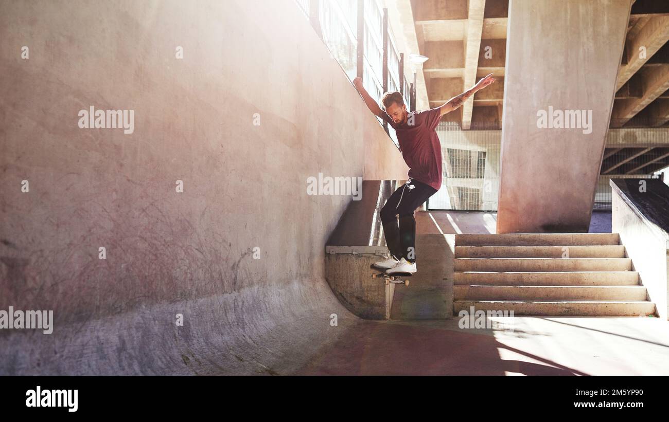 His kind of playground. a young man doing tricks on his skateboard at ...