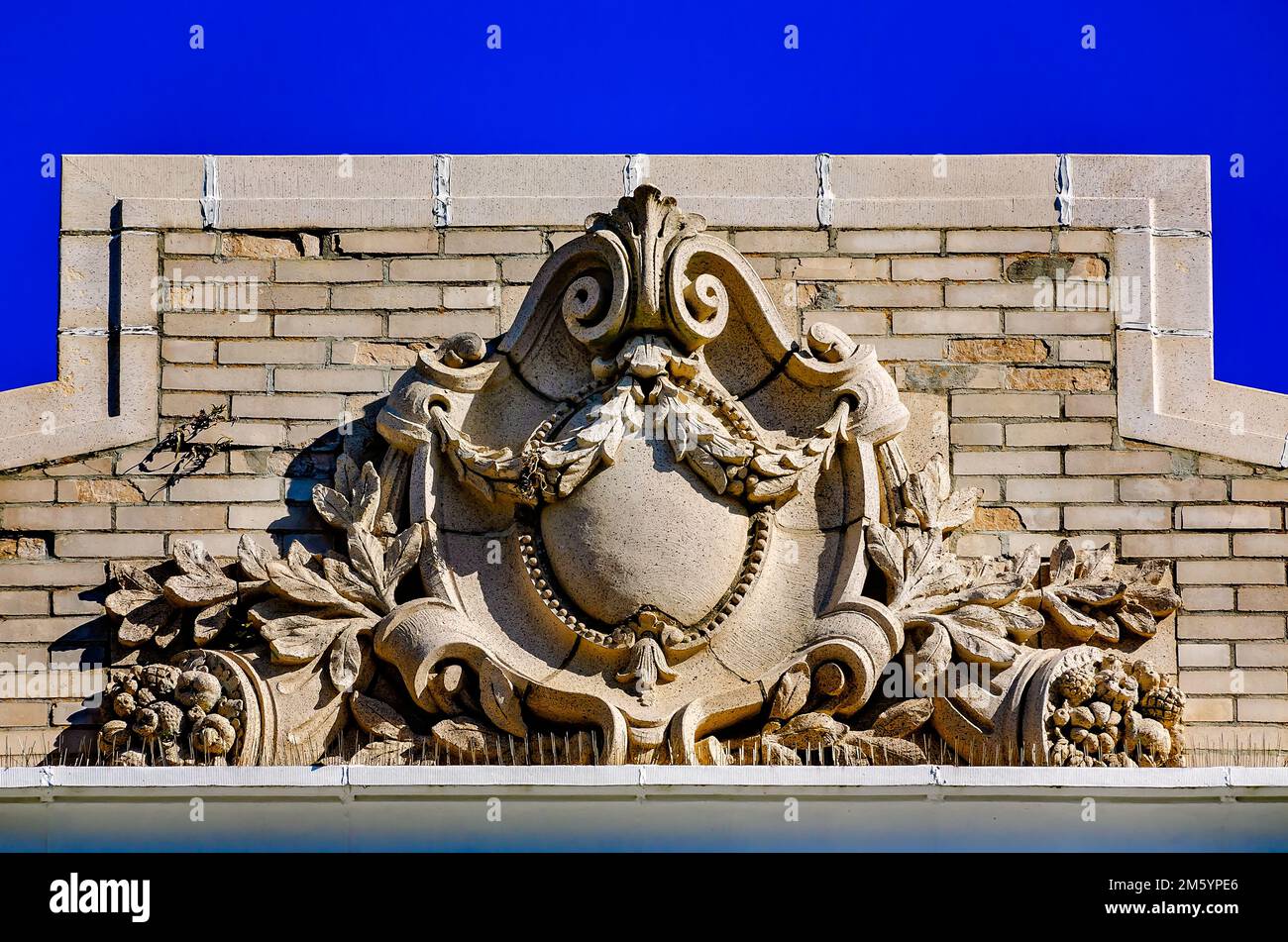 A decorative cartouche is mounted on the parapet of The Peoples Bank ...