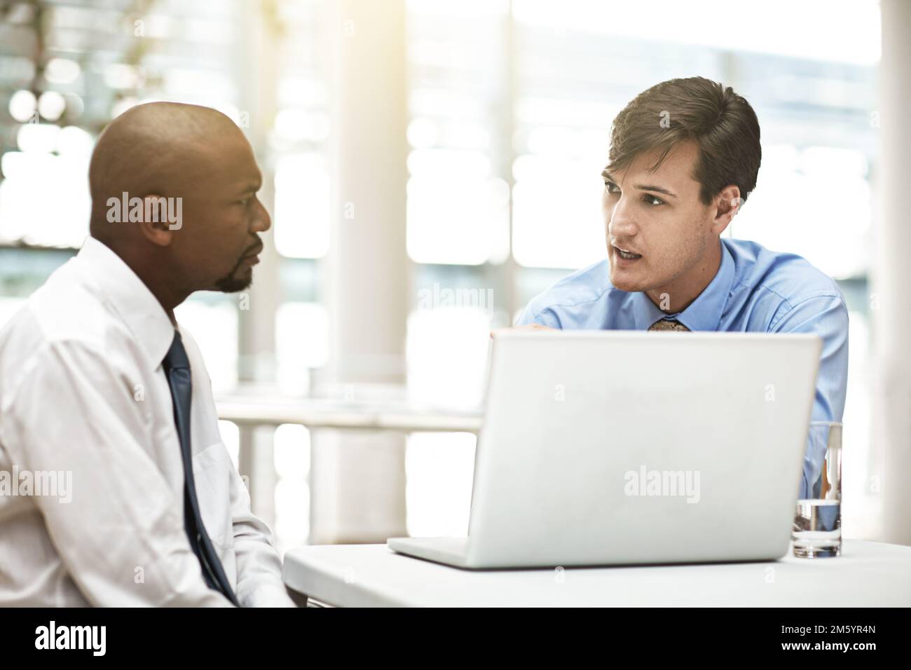 Two heads are better than one. two businessmen discussing work in the ...