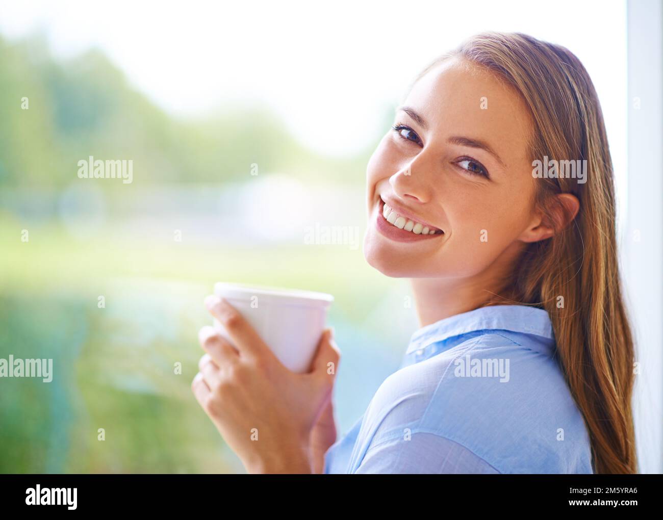 Unwinding with a nice cup of tea. Cropped portrait of a young woman ...