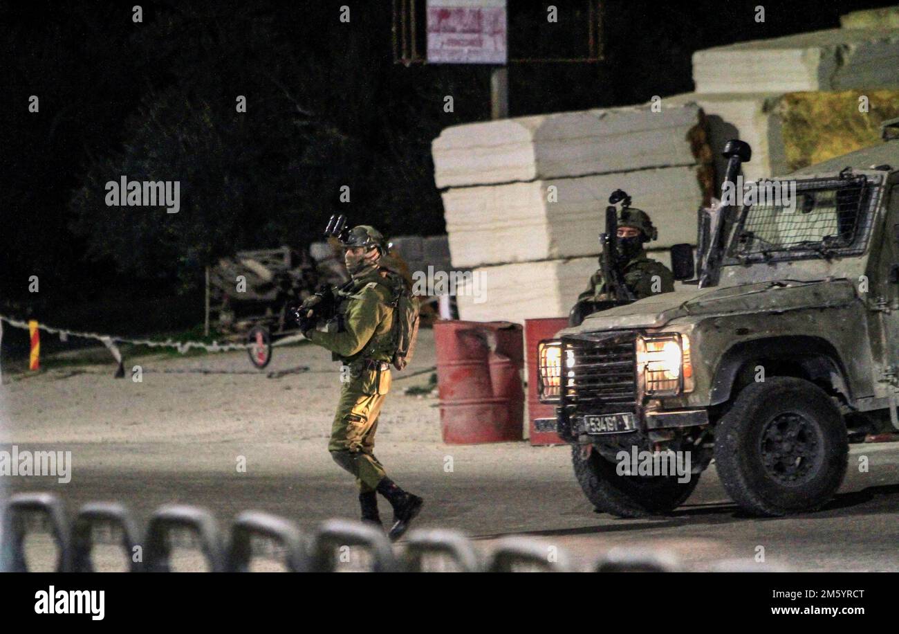 Israeli army forces block the street in front of Palestinians while guarding a march of Jewish ...