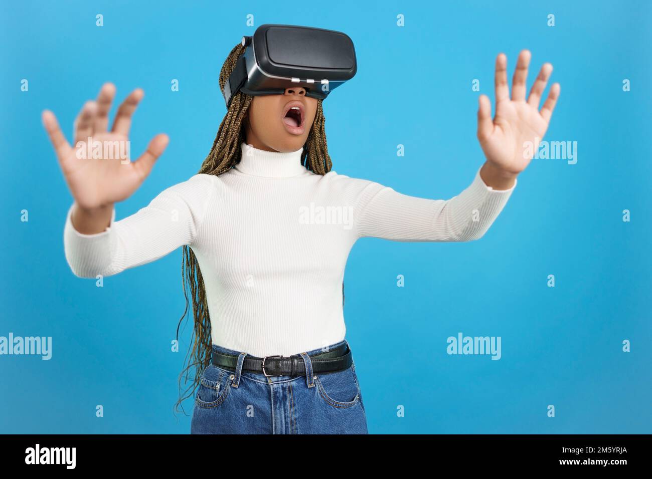 Shocked african woman wearing virtual reality goggles Stock Photo - Alamy