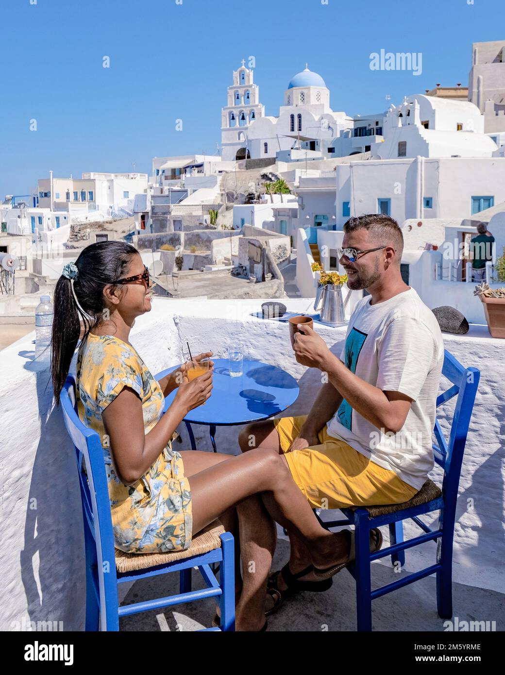 A couple on vacation in Santorini Greece, two men and women visit Oia ...