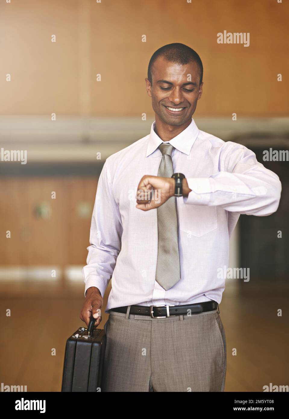 Perfect timing. a businessman checking the time Stock Photo - Alamy