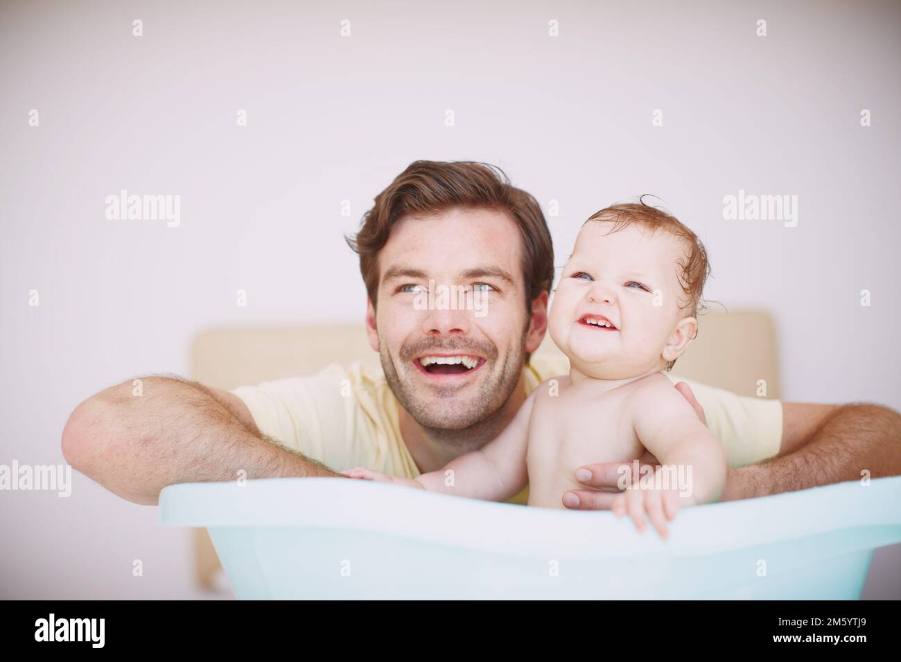 Dad and his adorable water baby. A young father bonding with his baby ...