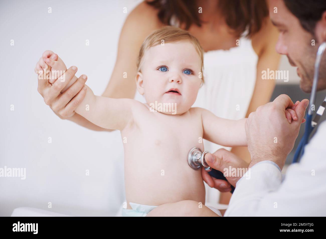 Shes a compliant little patient. A baby girl being examined by a doctor ...