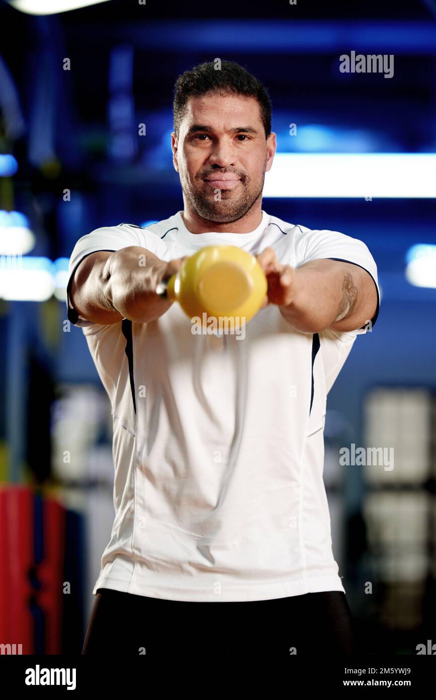 Bulking up with kettlebells. a man working out with kettle bells at the ...