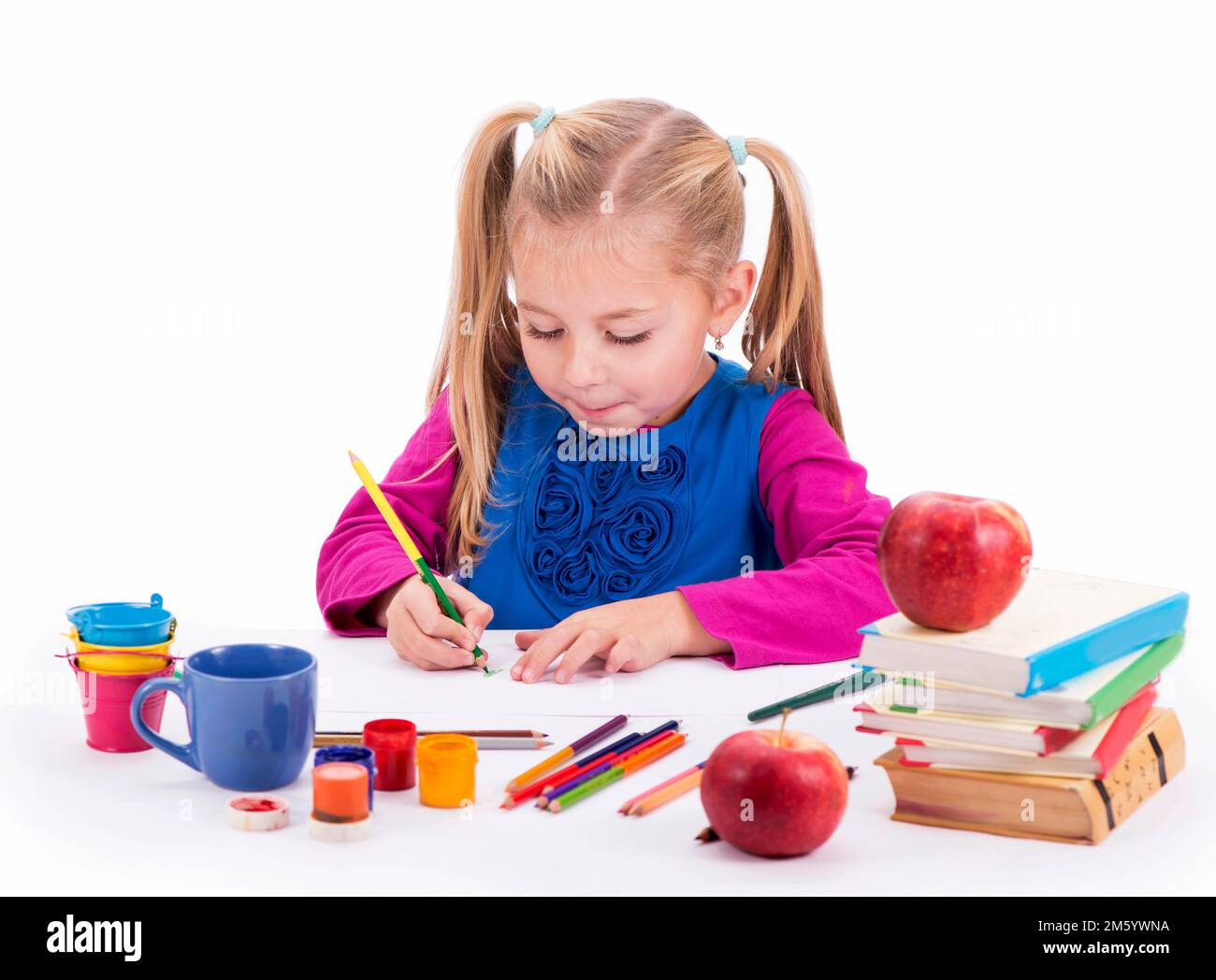 Children's hobbies, creativity, a little girl in a blue dress draws ...