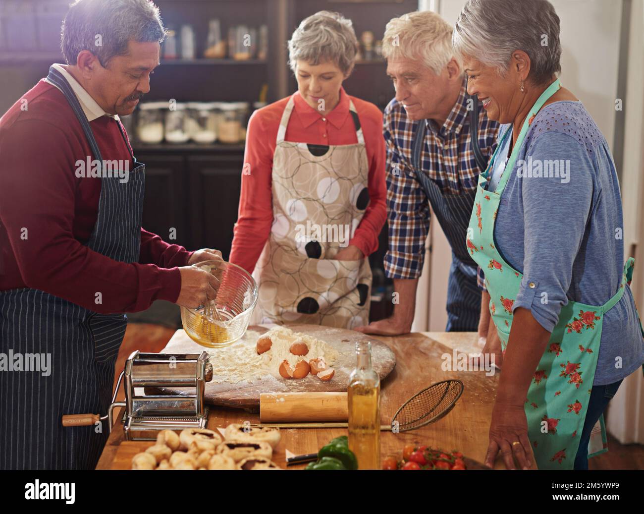 The art of pasta. a group of seniors cooking in the kitchen Stock Photo ...