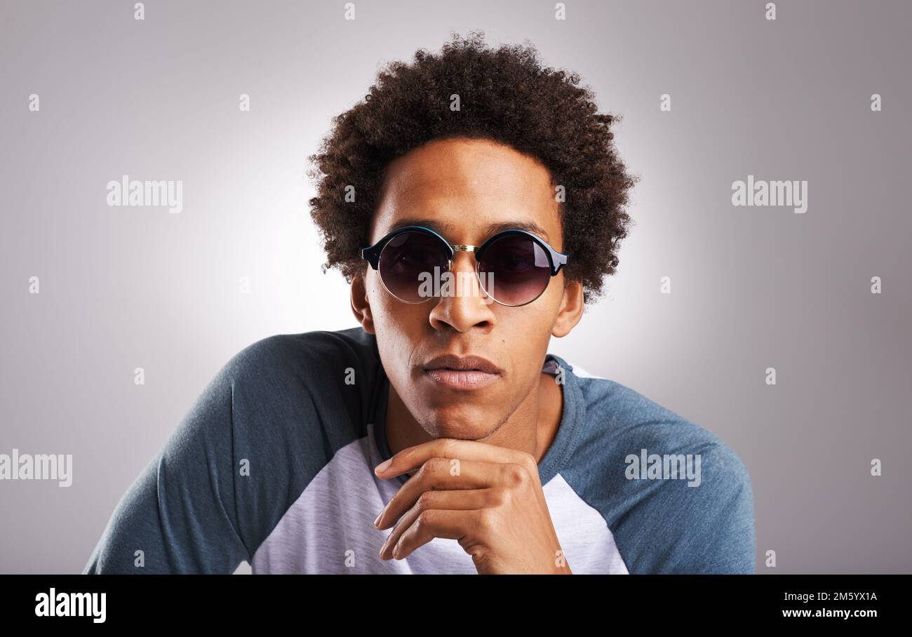 Keep calm and wear cool glasses. a young man posing with his sunglasses ...