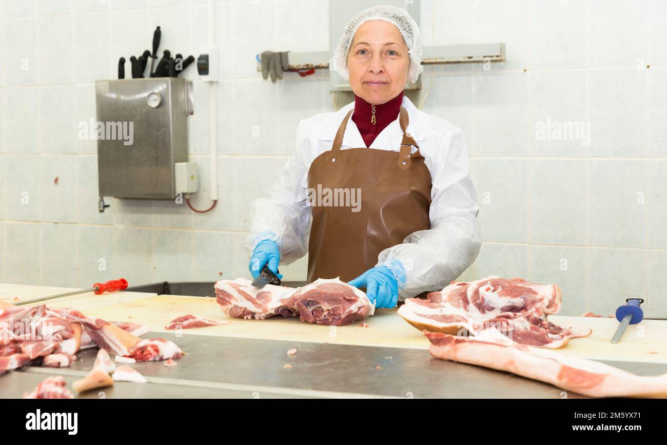 Female cutting raw meat Stock Photo - Alamy
